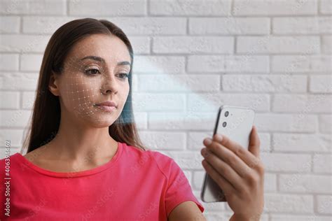 Babe Woman Unlocking Smartphone With Facial Scanner Near White Brick Wall Biometric