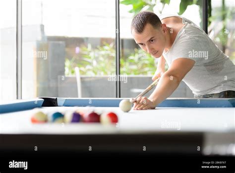 Handsome Man Leaning On Pool Table While Playing Billiard Stock Photo Alamy