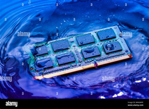 Technology Cyber Electronic Concept Cpu Ram Computer Fall Into The Water On Blue Light