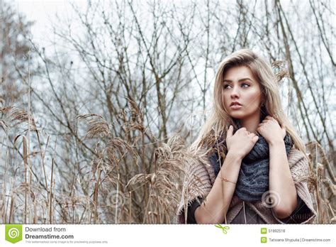 Portrait Of A Beautiful Girl With Blue Eyes In A Grey Jacket In The