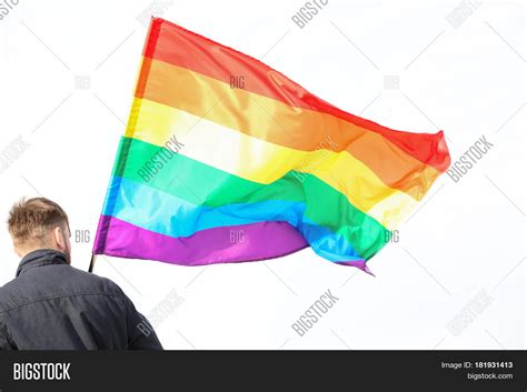 Man Holding Gay Flag On Light Background Stock Photo Stock Images