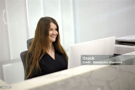 Long Hair Black Clothes White Computer Laptop Young Woman Sits At A Computer At The Reception Of
