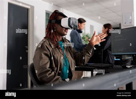 African American Database Admin Working With Virtual Reality Goggles To