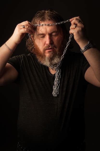 Premium Photo Mid Adult Man Wearing Chains While Standing Against