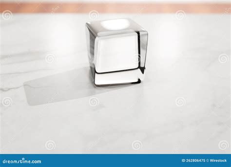 Piece Of Crystal Clear Square Ice On A Marble Table Surface Stock Image