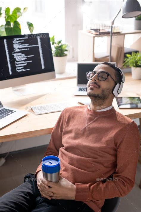 Tired Programmer Relaxing With Coffee In 2024 Listening To Music Handsome Programmer