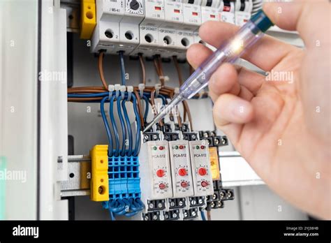 Electrician Testing Electrical Connections With Voltage Tester In