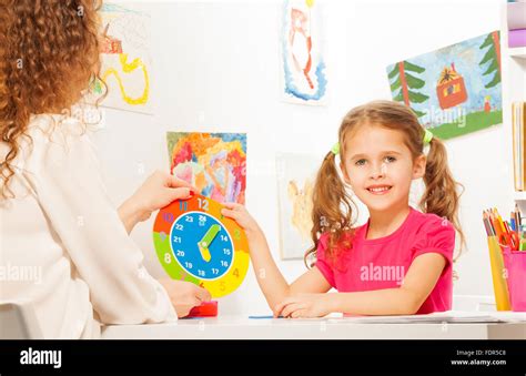 Girl Studying Time With The Cardboard Clock Model Stock Photo Alamy