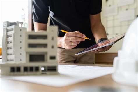 건축 계획을 위한 청사진을 작업하는 건축가 팀 건설 프로젝트를 스케치하는 엔지니어 녹색 에너지 개념 개념에 대한 스톡 사진 및