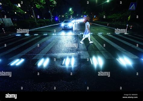 A Pedestrian Walks On An Intelligent Zebra Crossing As The Lights