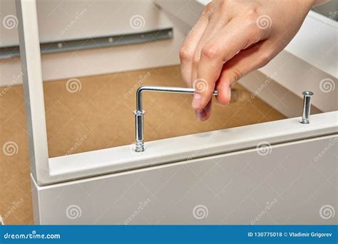 Furniture Assembler Tightens Furniture Connector Into Table With Stock