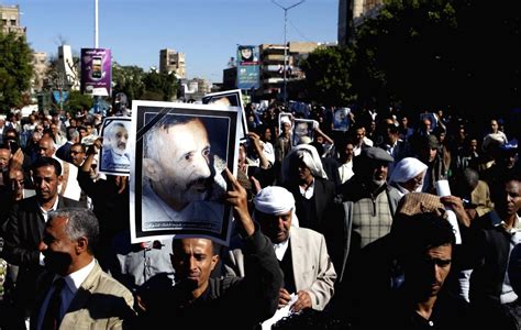 Yemenis Hold Pictures Of Mohammed Abdulmalik Al Mutawakil During A Funeral