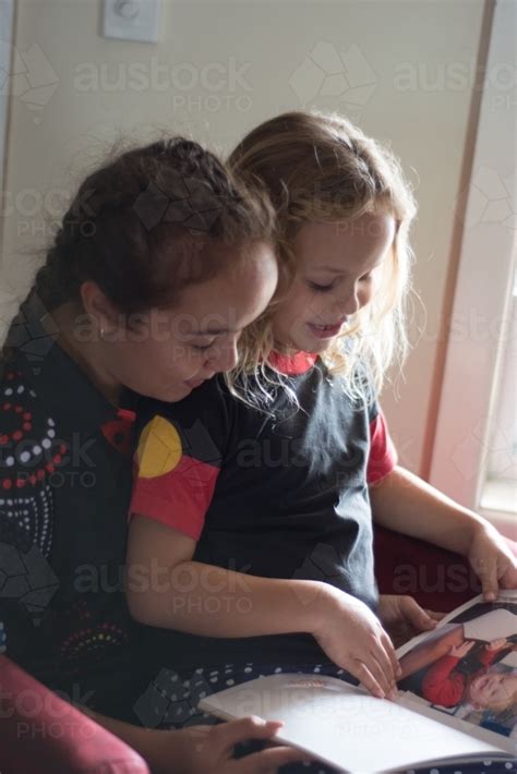 Image Of Sisters Reading Together Austockphoto