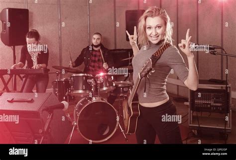 Attractive Female Soloist Playing Guitar And Singing With Her Mu Stock
