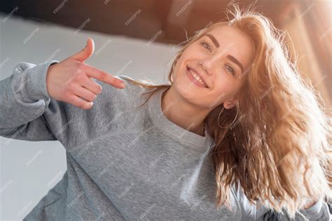 Free Photo Beautiful Young Woman Pointing Her Finger At Herself