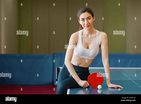 Woman With Racket And Ball Poses At The Ping Pong Table Indoors Female Person In Sportswear