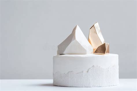 A Striking Minimalist Cake Features Sharp Angular Fondant Textures And Metallic Geometric
