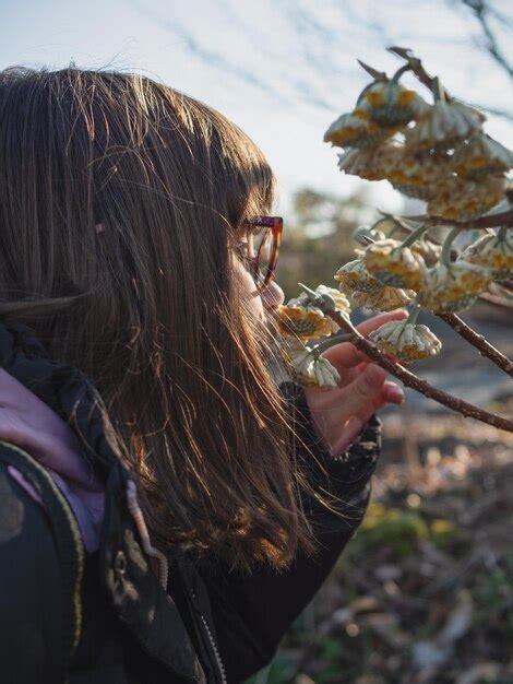 Premium Photo Close Up Girl Smelling Tree Flower