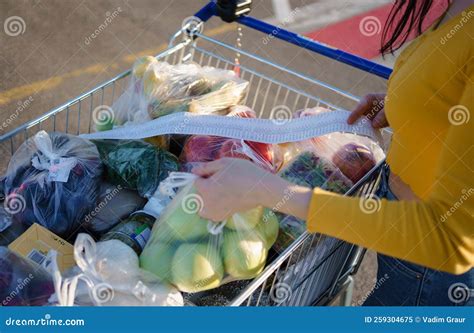 Close Up Woman Checks Paper Check After Shopping For Groceries At Mall By Checking Dear Amount