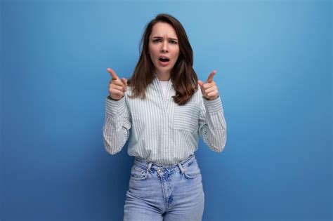 Premium Photo Pretty Young Brunette Woman In Shirt Points Finger On