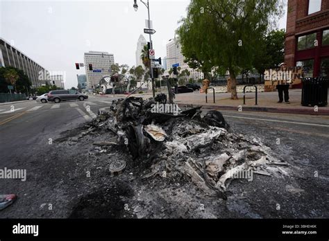 A Burned Out Car Sits Destroyed After A Night Of Protests In Downtown