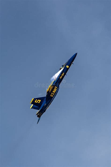 A Small Fighter Jet Flying Through The Blue Sky With Smoke Coming Out