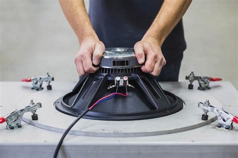 Premium Photo Worker Check The Speaker At The Factory