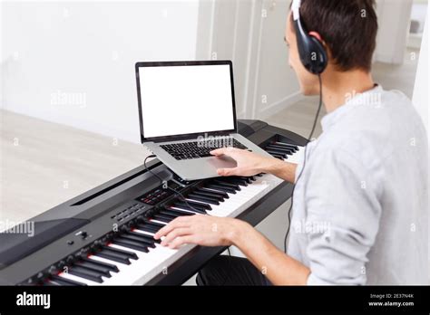 Male Composer Hands Using Computer Midi Keyboard And Studio Equipment