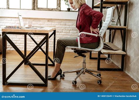 Attractive Short Haired Office Worker Having Problems With Bones And