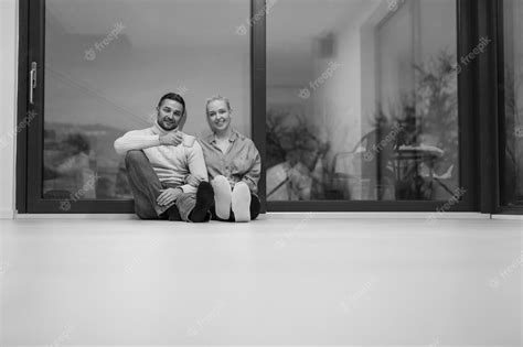 Premium Photo Young Romantic Couple Sitting On The Floor In Front Of