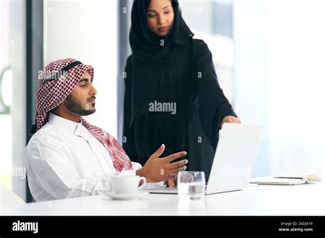 Putting Productivity First Two Muslim Coworkers Using A Laptop