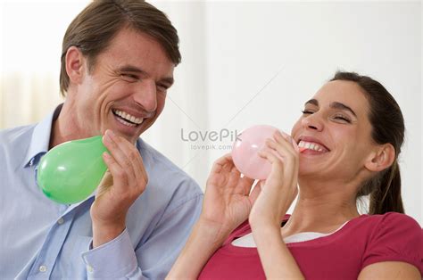 A Couple Blowing Balloons Picture And Hd Photos Free Download On Lovepik