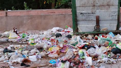 Open Garbage Dust Bin Liter With Plastic Begs And Waste Items At Day