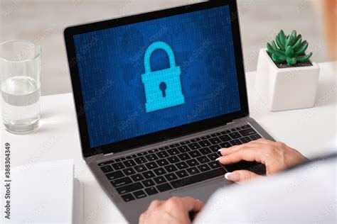 Woman Typing On Laptop Keyboard Padlock Icon On The Screen Stock Photo Adobe Stock