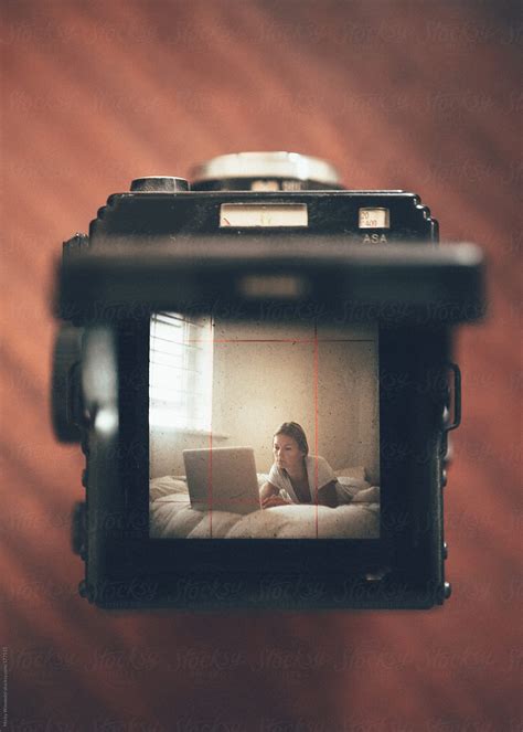 Girl On Her Laptop Shot Through Dirty Screen Of A Vintage Medium Format Camera By Stocksy