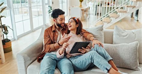 Home Funny And Couple On Sofa Tablet And Bonding Together With
