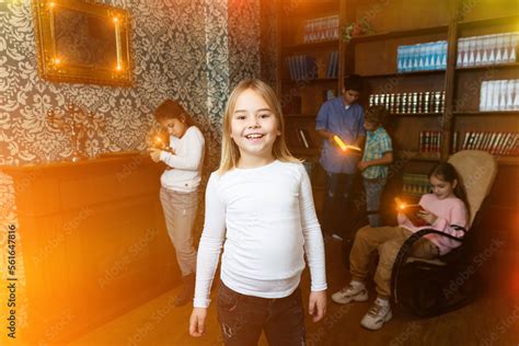 Portrait Of Cheerful Cute Preteen Girl Having Fun In Quest Room With Her Friends Toned Image