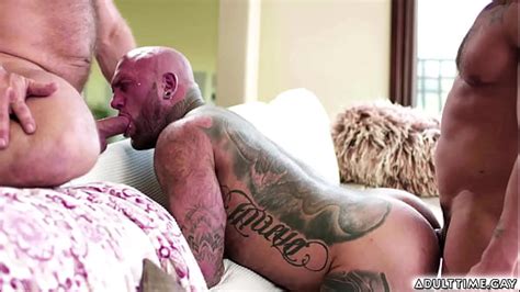 couples brock banks and rick kelson are cuddling at the sofa and