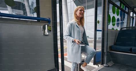 트롤리 여행 가방과 탑승권을 들고 웃고 있는 행복한 여행자 공항 셔틀 버스 타기 사진 Unsplash의 여행 가방 이미지