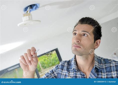 Man Fitting Spotlight In Ceiling Royalty Free Stock Photography CartoonDealer Com