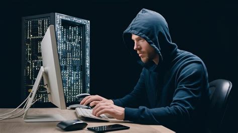 Premium Photo Dangerous Anonymous Hacker Man In Black Hooded Using