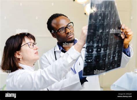 Man And Woman In White Lab Coats Conducting Experiment Stock Photo Alamy