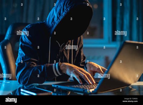 Anonymous Hacker Programmer Uses A Laptop To Hack The System In The