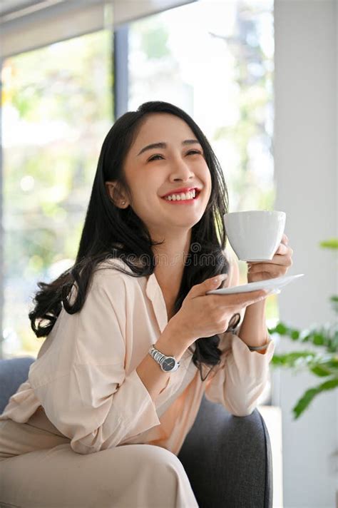 Attractive Asian Businesswoman Or Female Manager Enjoys Having Coffee