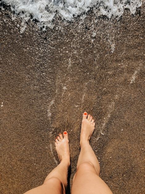 Premium Photo Woman Legs Barefoot At Sea Foam Waves On Sand Beach