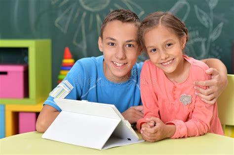 Portrait Of Brother And Babe Using Tablet Stock Photo Image Of Microcircuits Girl 308917442