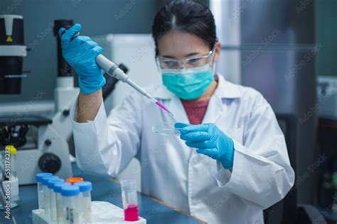 Scientist Woman Use Micropipette With Sample Preparation From Test Tube Of Sample Stock Solution