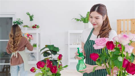 아름다운 아시아 여성 꽃집은 꽃 가게의 꽃에 물을 뿌리고 꽃에 수분과 활력을 더하고 꽃 가게에서 꽃이 시드는 것을 방지합니다 꽃집 개념 중소기업 소유자 20 24세에 대한