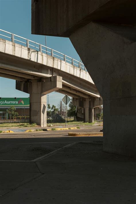A View Of A Highway Underpass With A Car Driving Under It · Free Stock