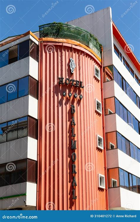 Corner Facade Of An Office Building With Lots Of Glass And Metal Gardens With Hedges And Long